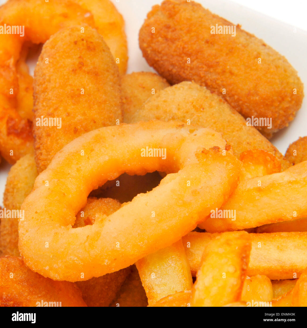 closeup of a spanish combo platter with croquettes, calamares and ...