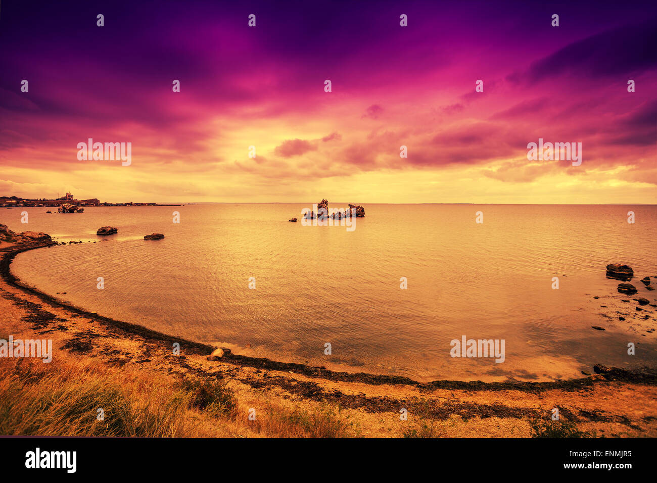 Purple sunset over beach with dramatic sky Stock Photo - Alamy