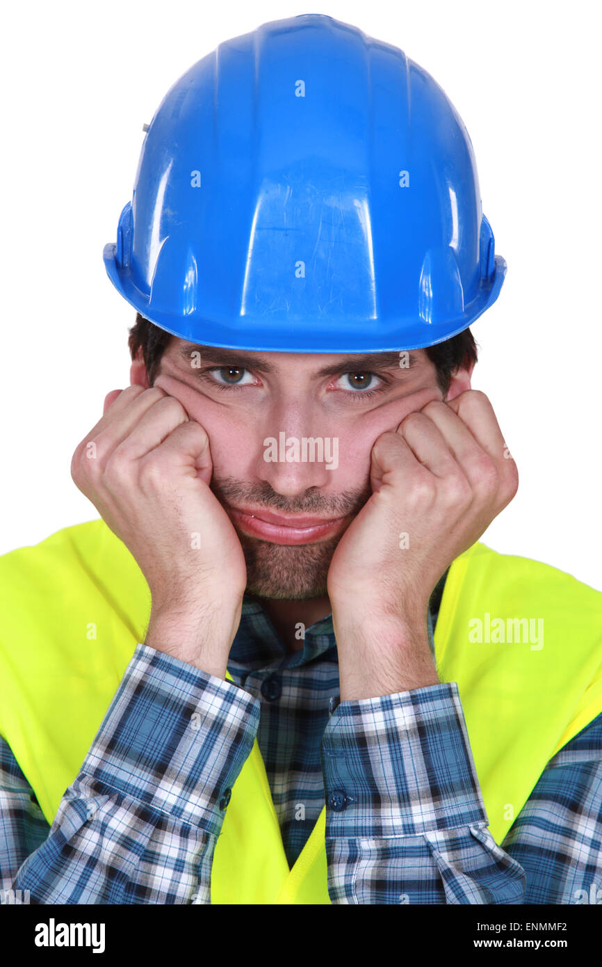 A grumpy and frustrated tradesman Stock Photo - Alamy