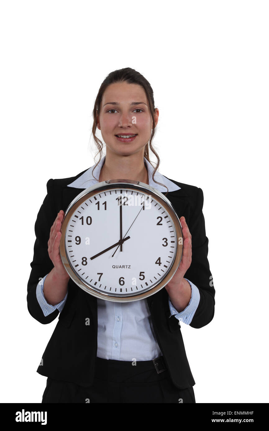woman in a suit holding a huge clock Stock Photo - Alamy