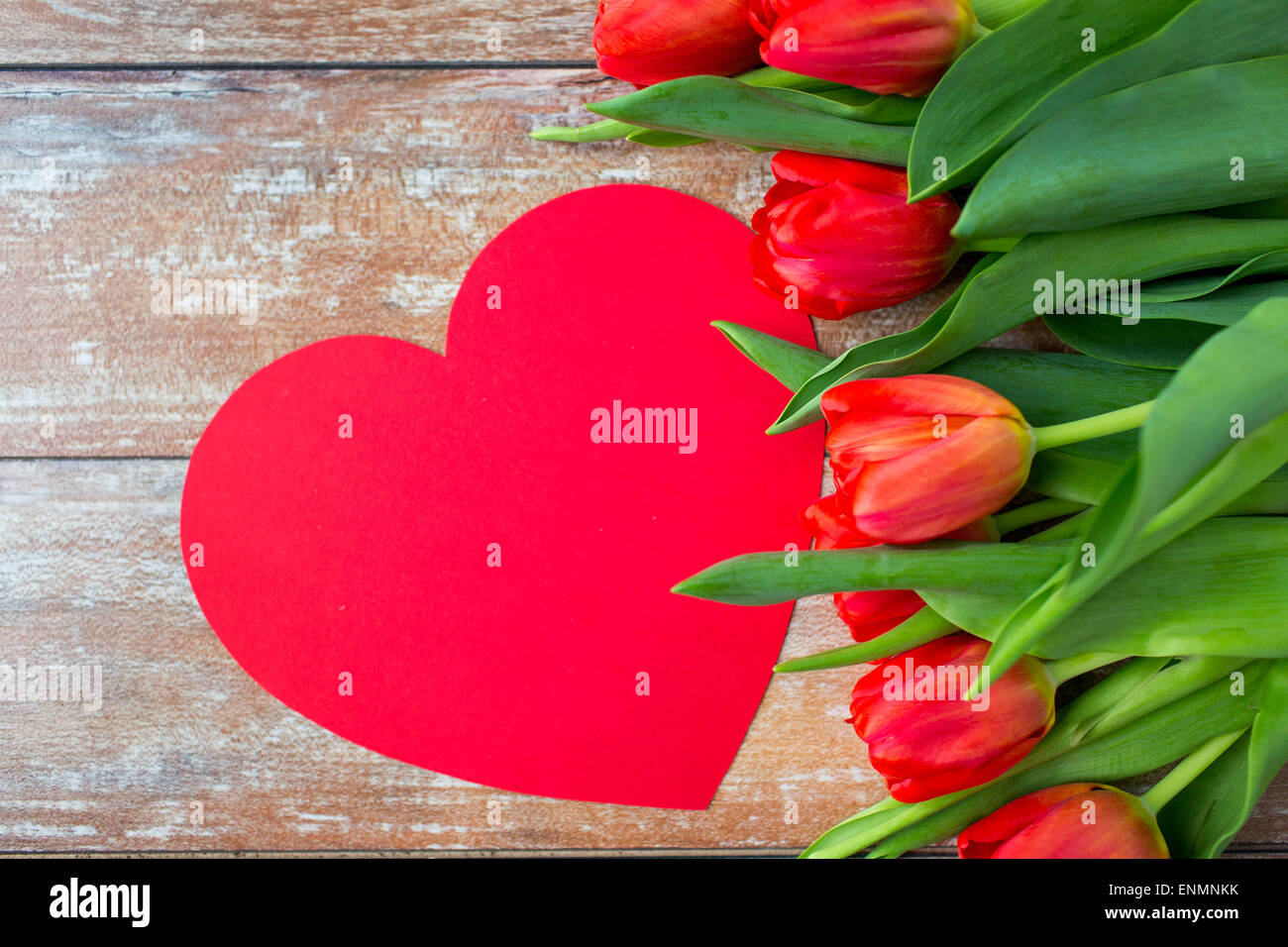 close up of red tulips and paper heart shape card Stock Photo - Alamy