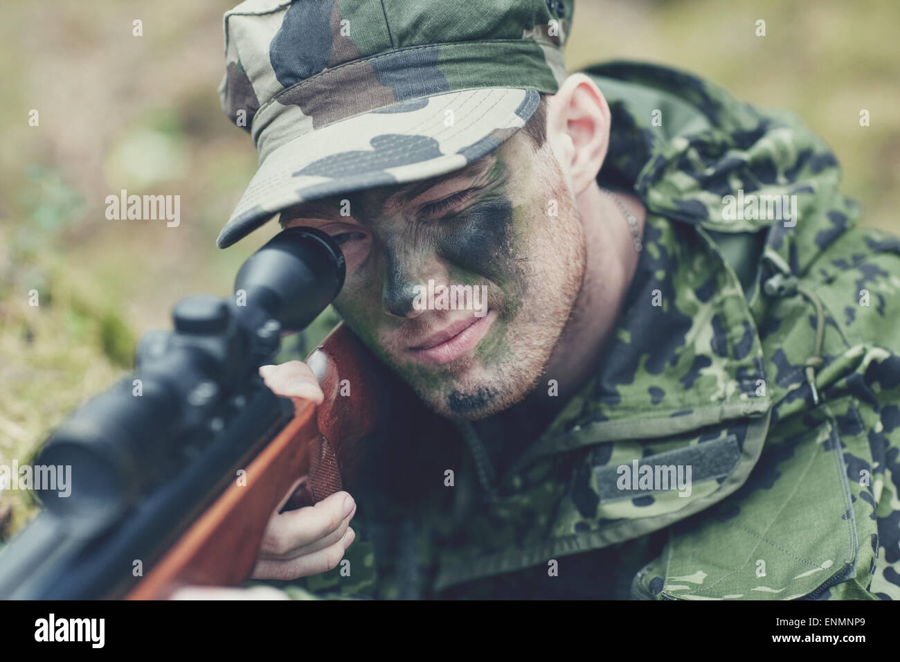 soldier or hunter shooting with gun in forest Stock Photo - Alamy
