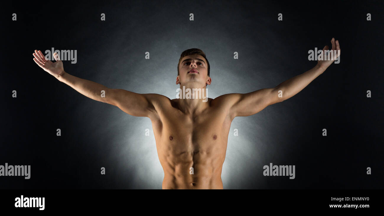 young male bodybuilder with raised hands Stock Photo - Alamy