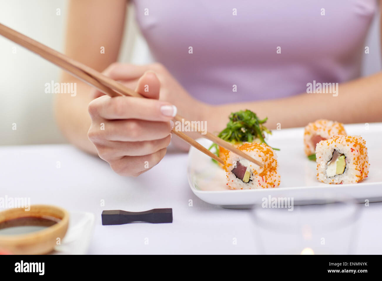 Woman eating sushi hi-res stock photography and images - Alamy