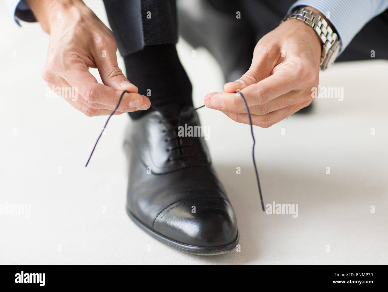 close up of man leg and hands tying shoe laces Stock Photo - Alamy