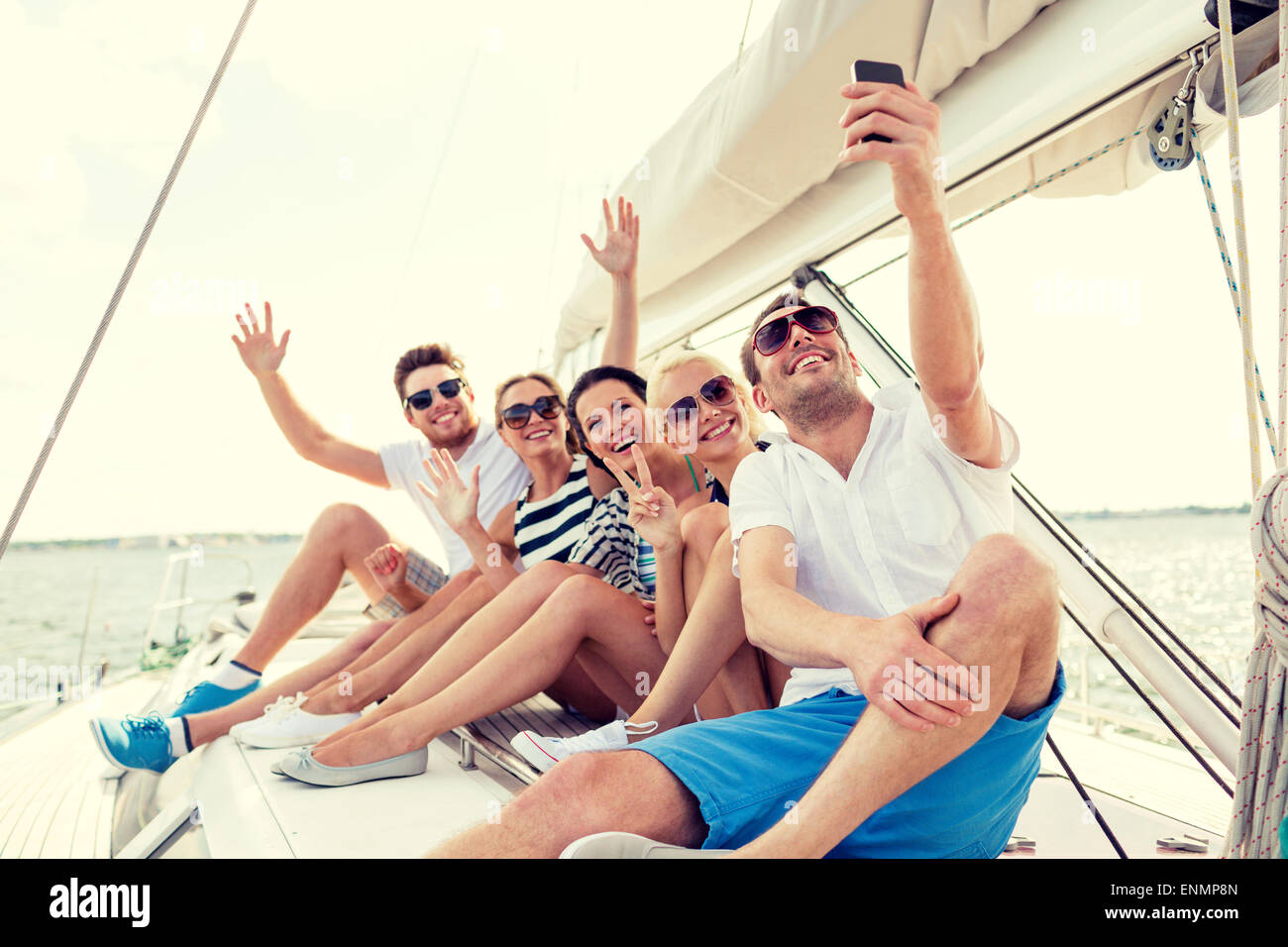 smiling friends sitting on yacht deck Stock Photo - Alamy
