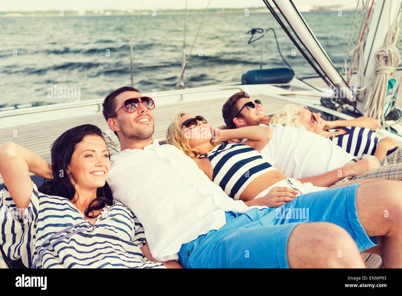 smiling friends lying on yacht deck Stock Photo - Alamy