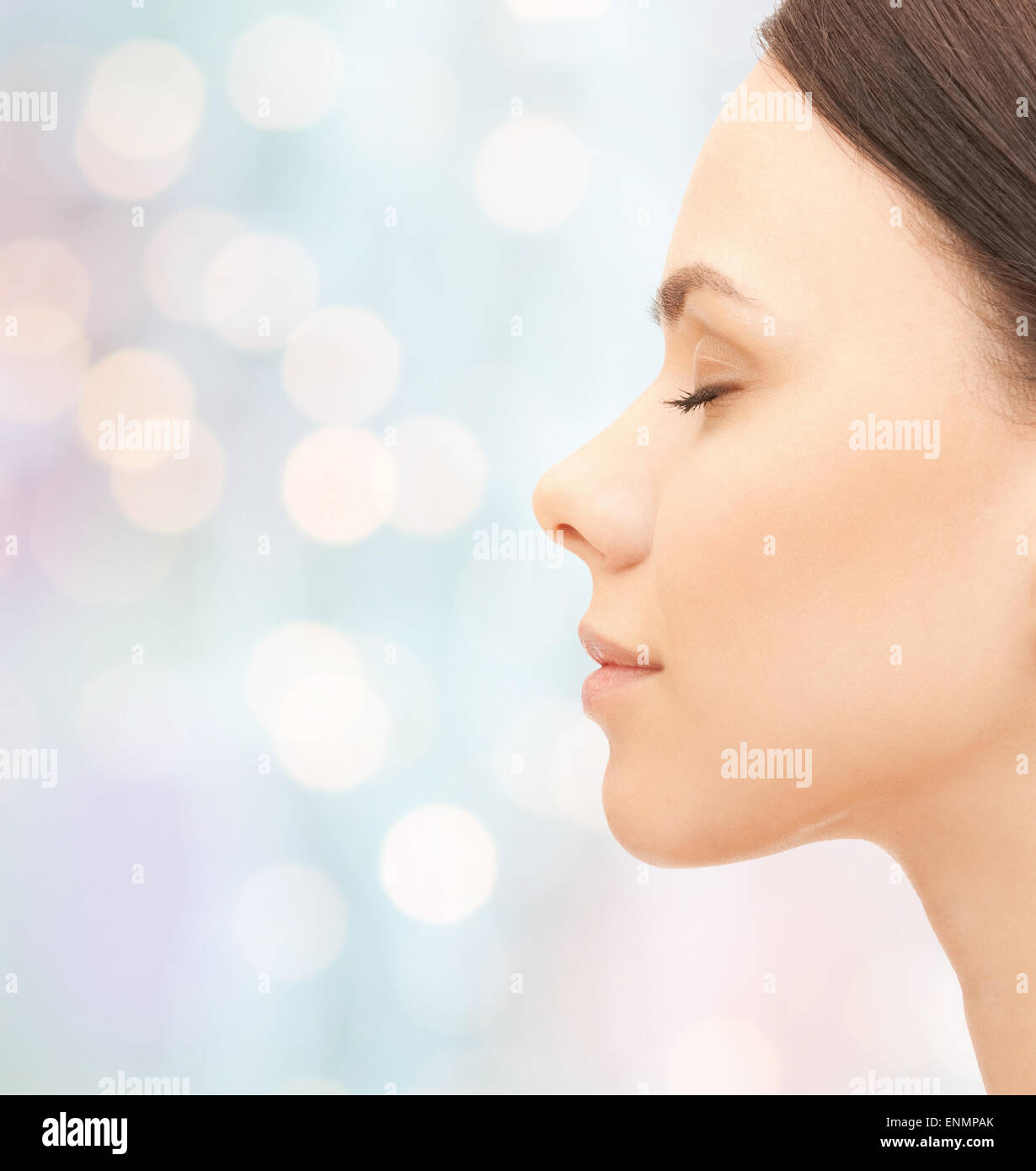 beautiful young woman face over blue background Stock Photo - Alamy
