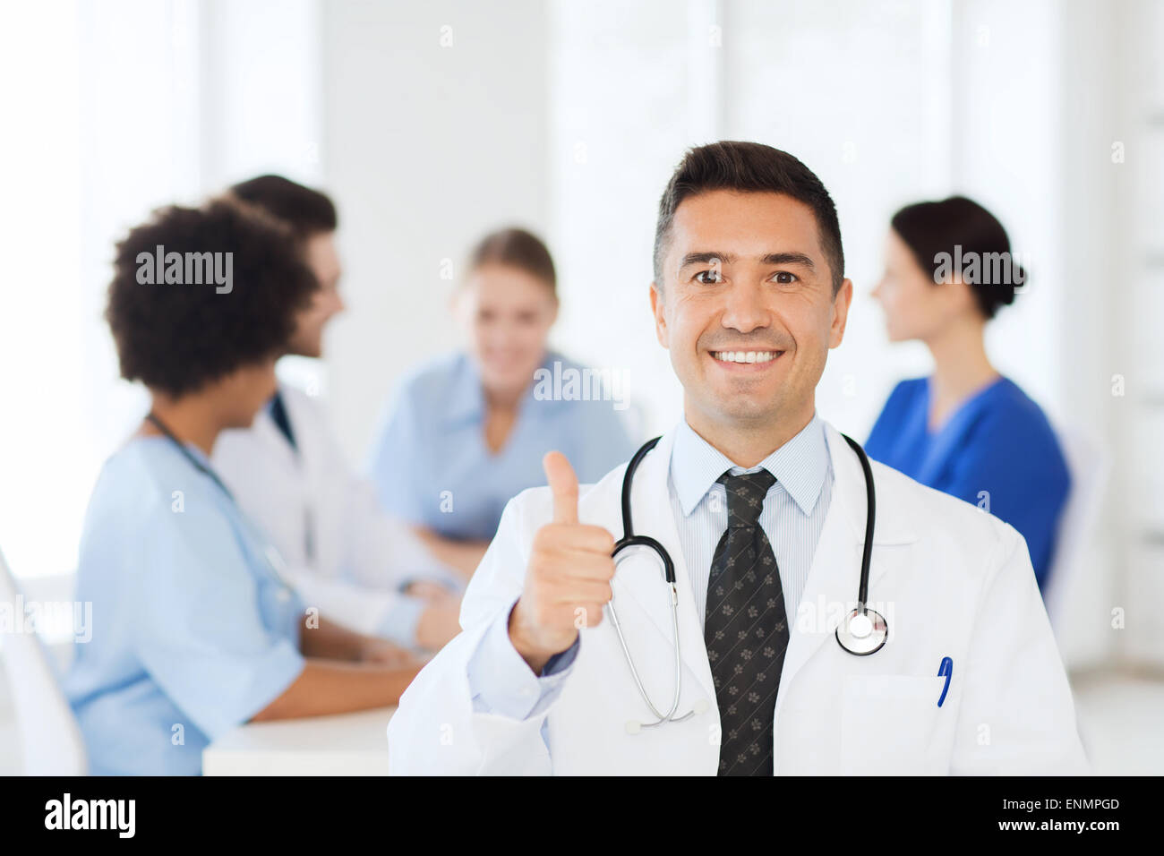 happy doctor over group of medics at hospital Stock Photo - Alamy