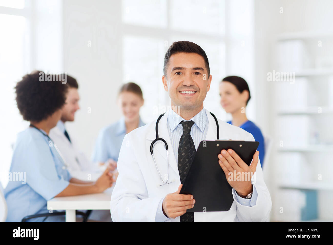 happy doctor with clipboard over medical team Stock Photo - Alamy