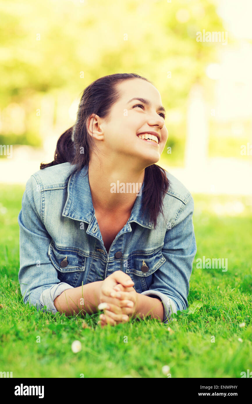 smiling young girl lying on grass Stock Photo - Alamy