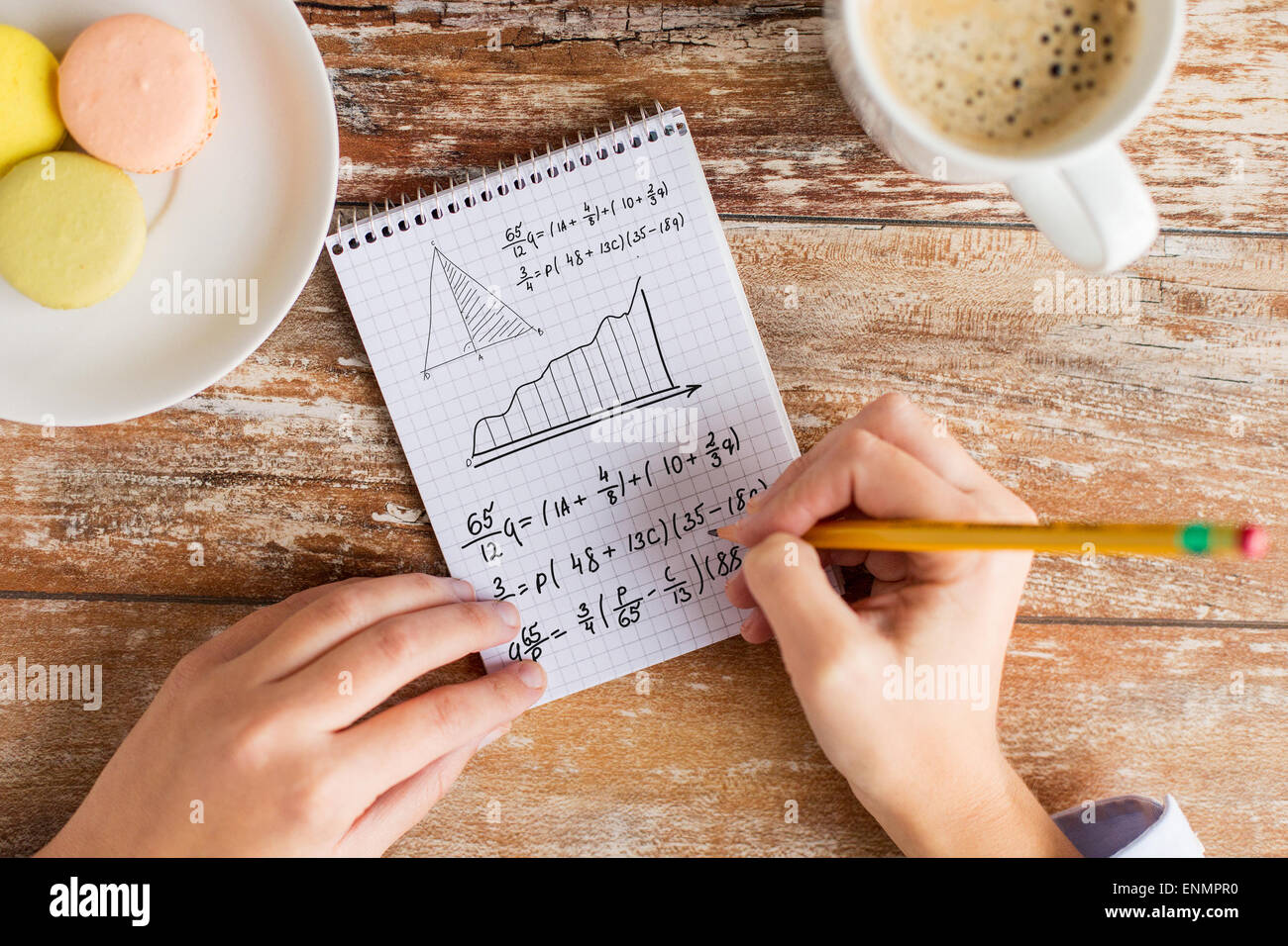 close up of hands writing mathematical equation Stock Photo - Alamy