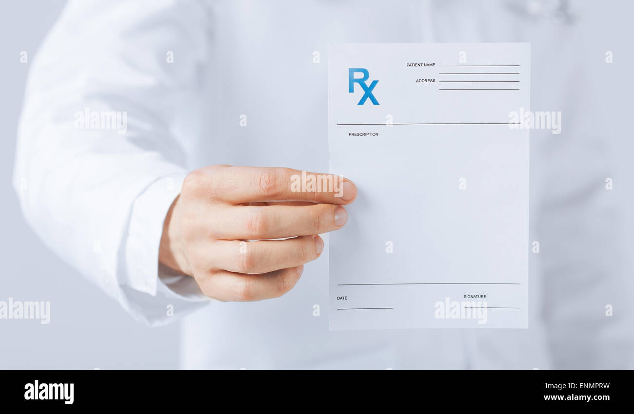 male doctor holding rx paper in hand Stock Photo - Alamy