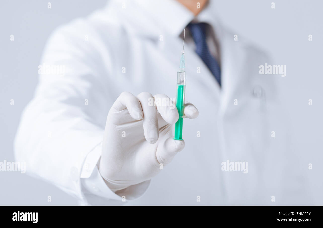 male doctor holding syringe with injection Stock Photo - Alamy
