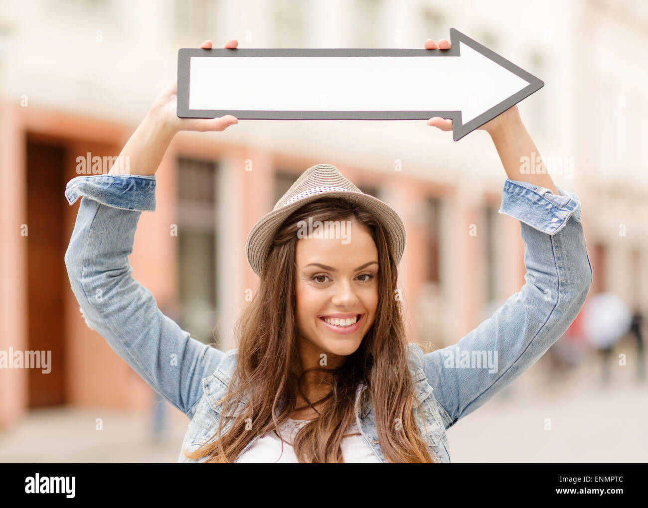 girl showing direction with arrow in the city Stock Photo - Alamy