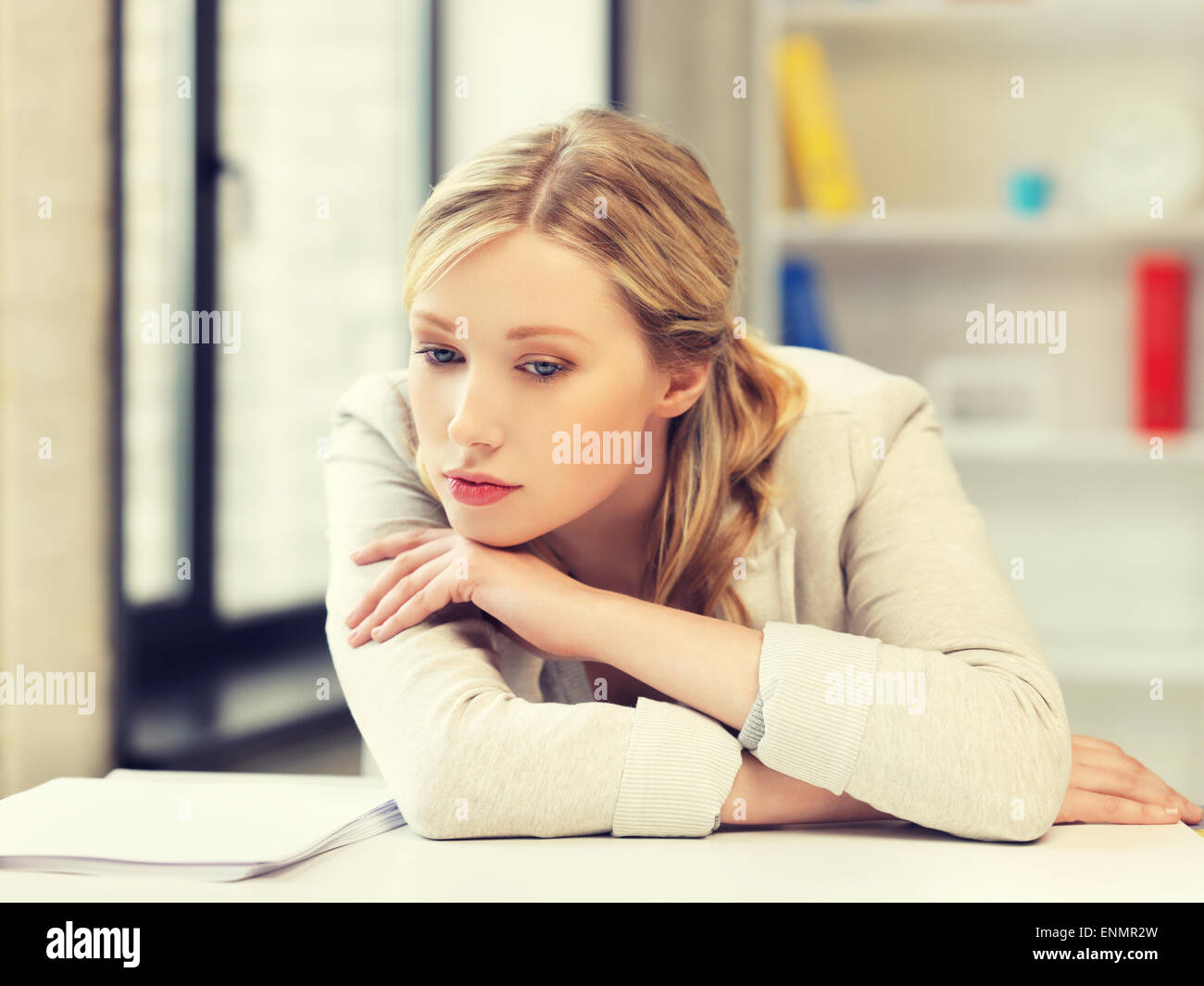 bored and tired woman behind the table Stock Photo - Alamy