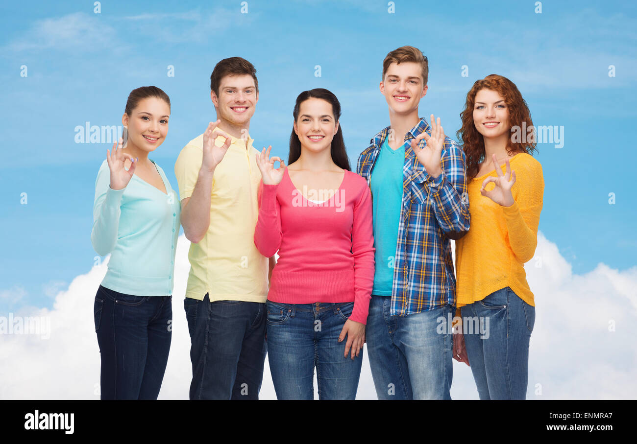 group of smiling teenagers showing ok sign Stock Photo - Alamy