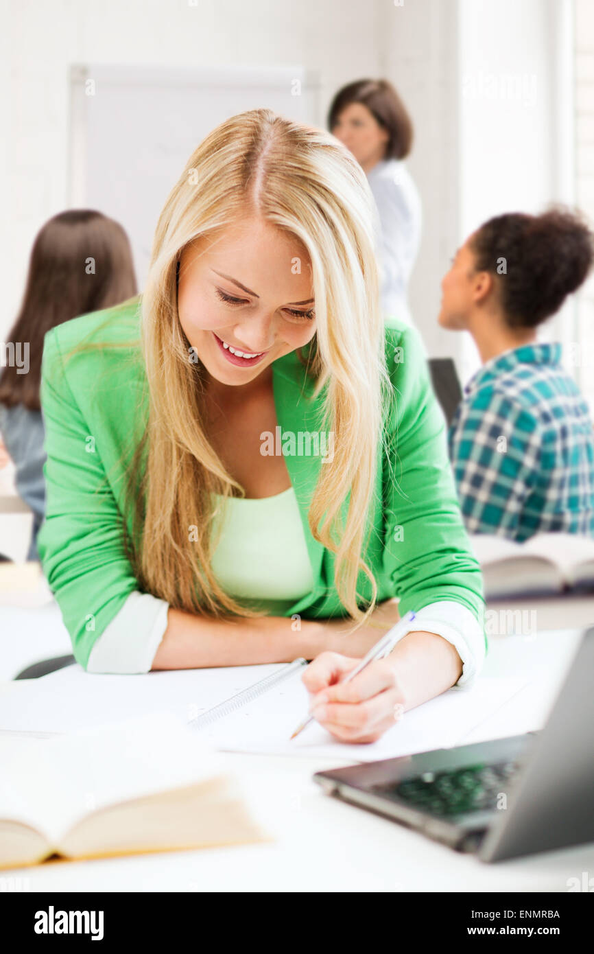 student girl writing in notebook at school Stock Photo - Alamy