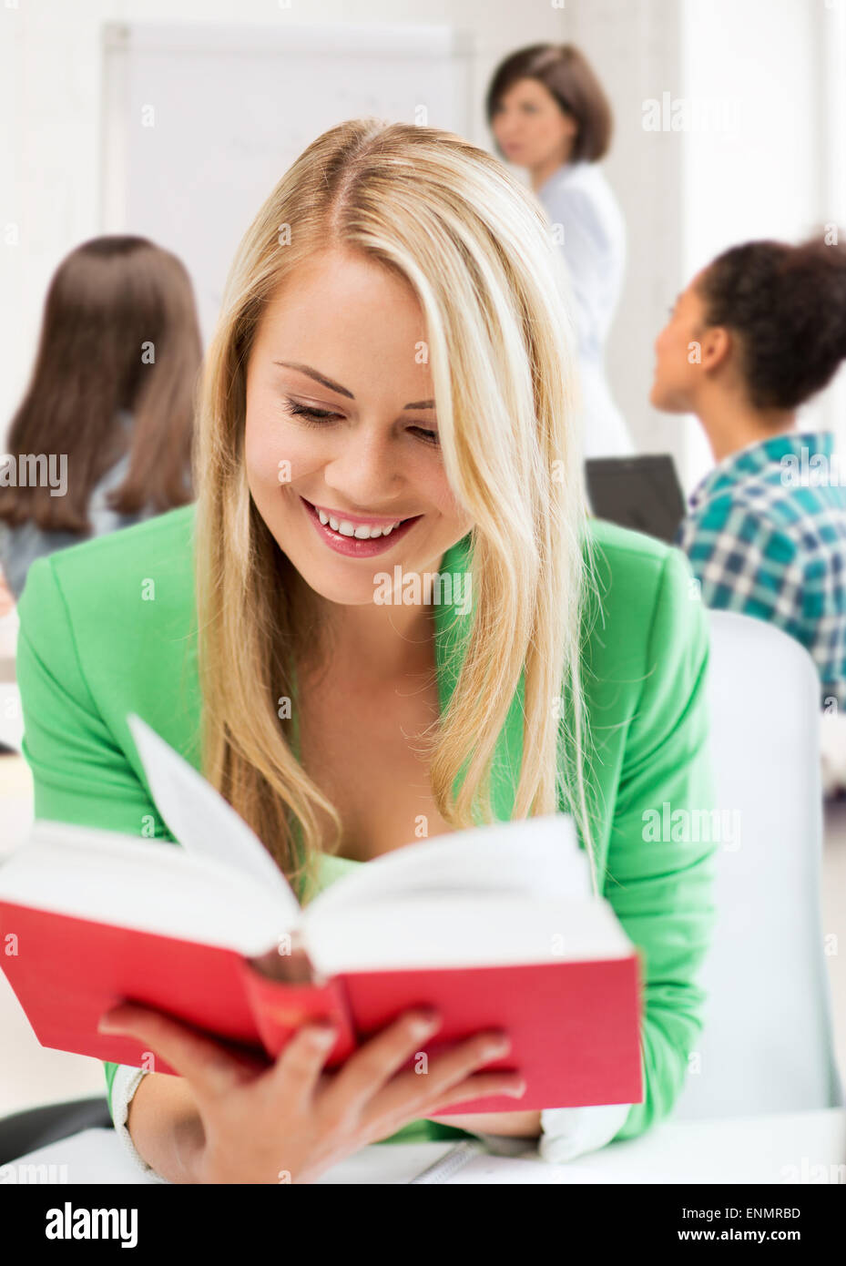 smiling student girl reading book at school Stock Photo - Alamy