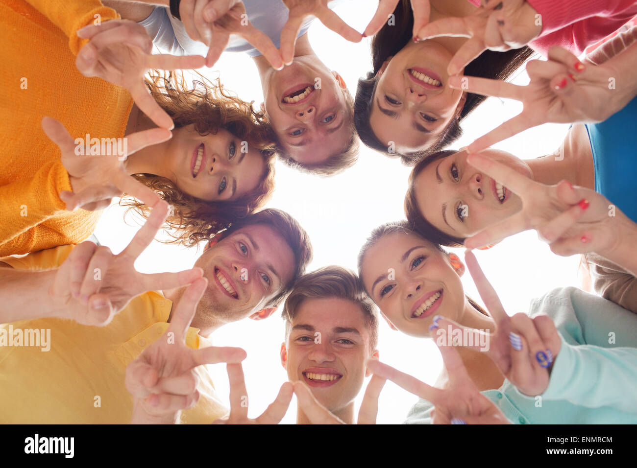 group of smiling teenagers showing victory sign Stock Photo - Alamy