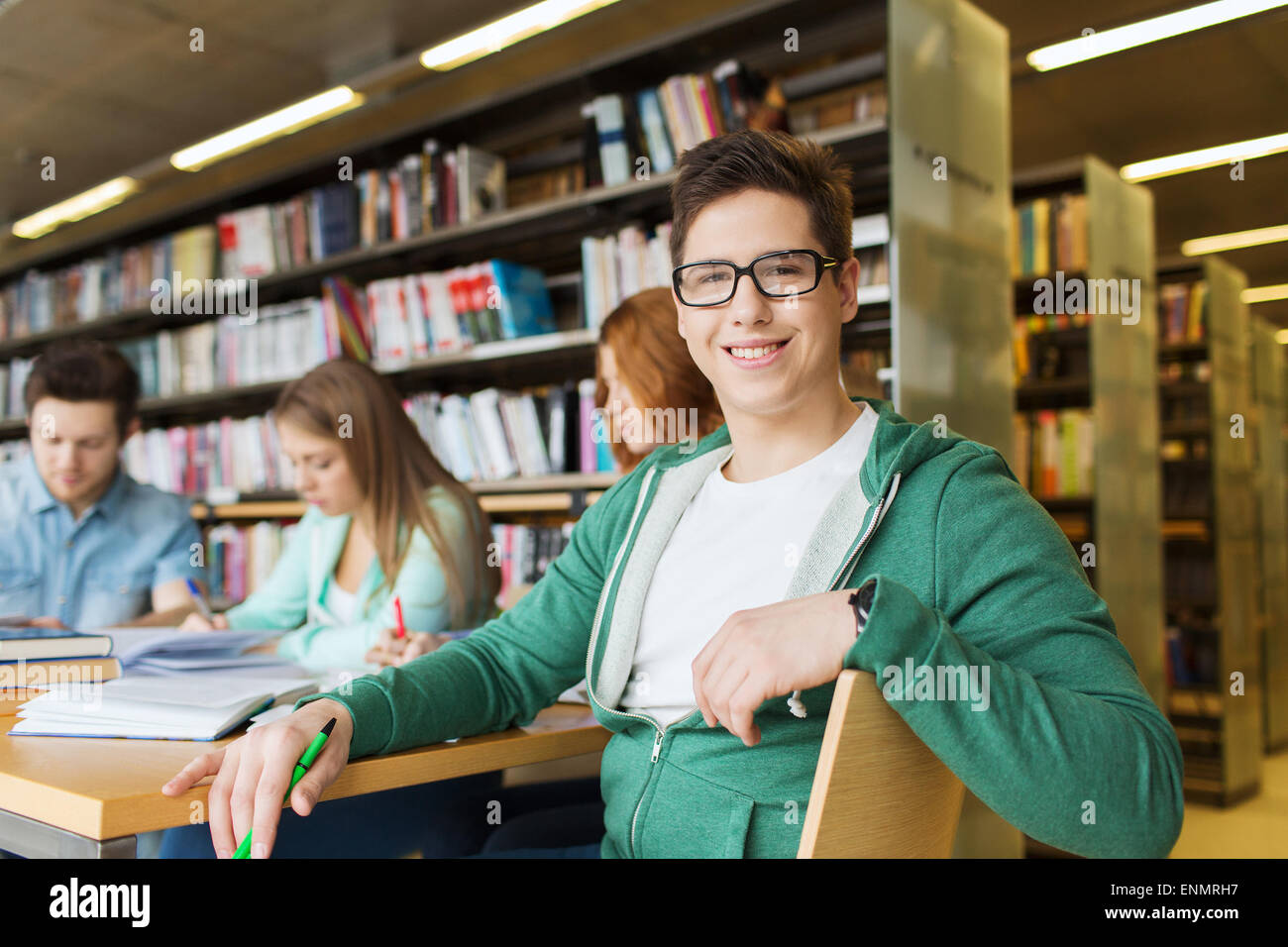 happy student boy reading books in library Stock Photo - Alamy