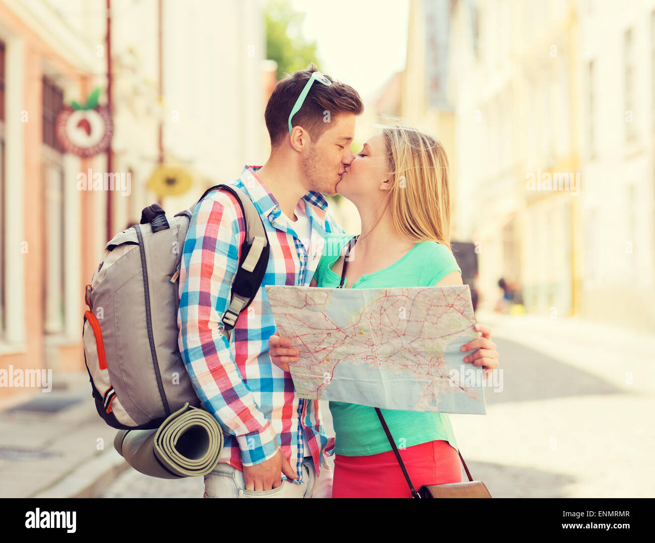 smiling couple with map and backpack in city Stock Photo - Alamy