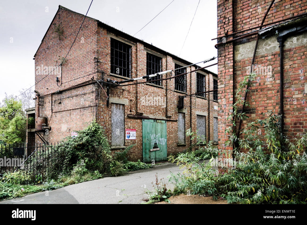 A deserted factory building with weeds taking over the buildings Stock ...