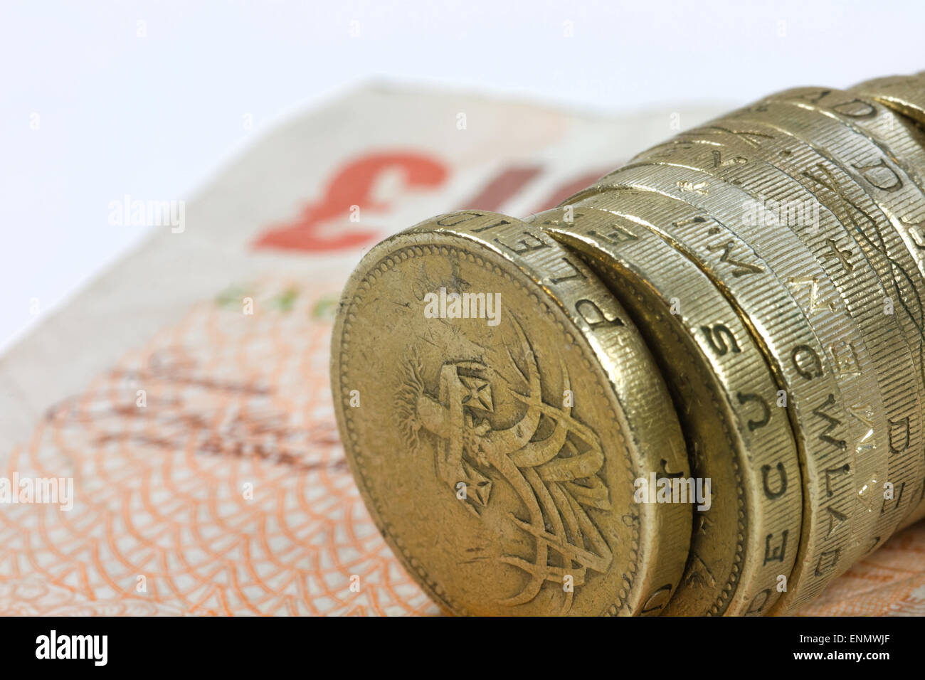 One pound coins on the edge on a white background Stock Photo - Alamy