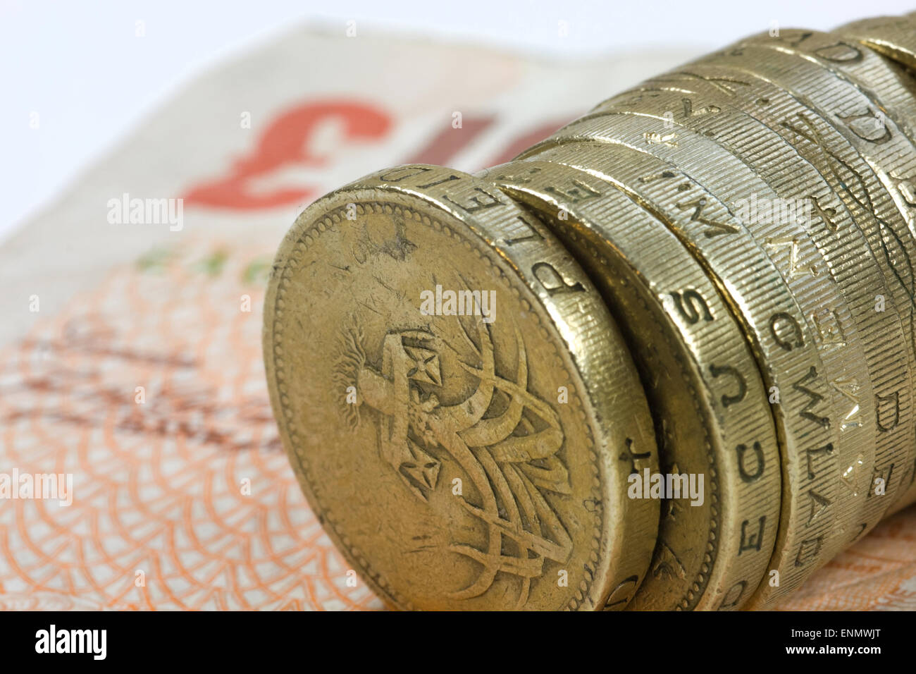 One pound coins on the edge on a white background Stock Photo - Alamy
