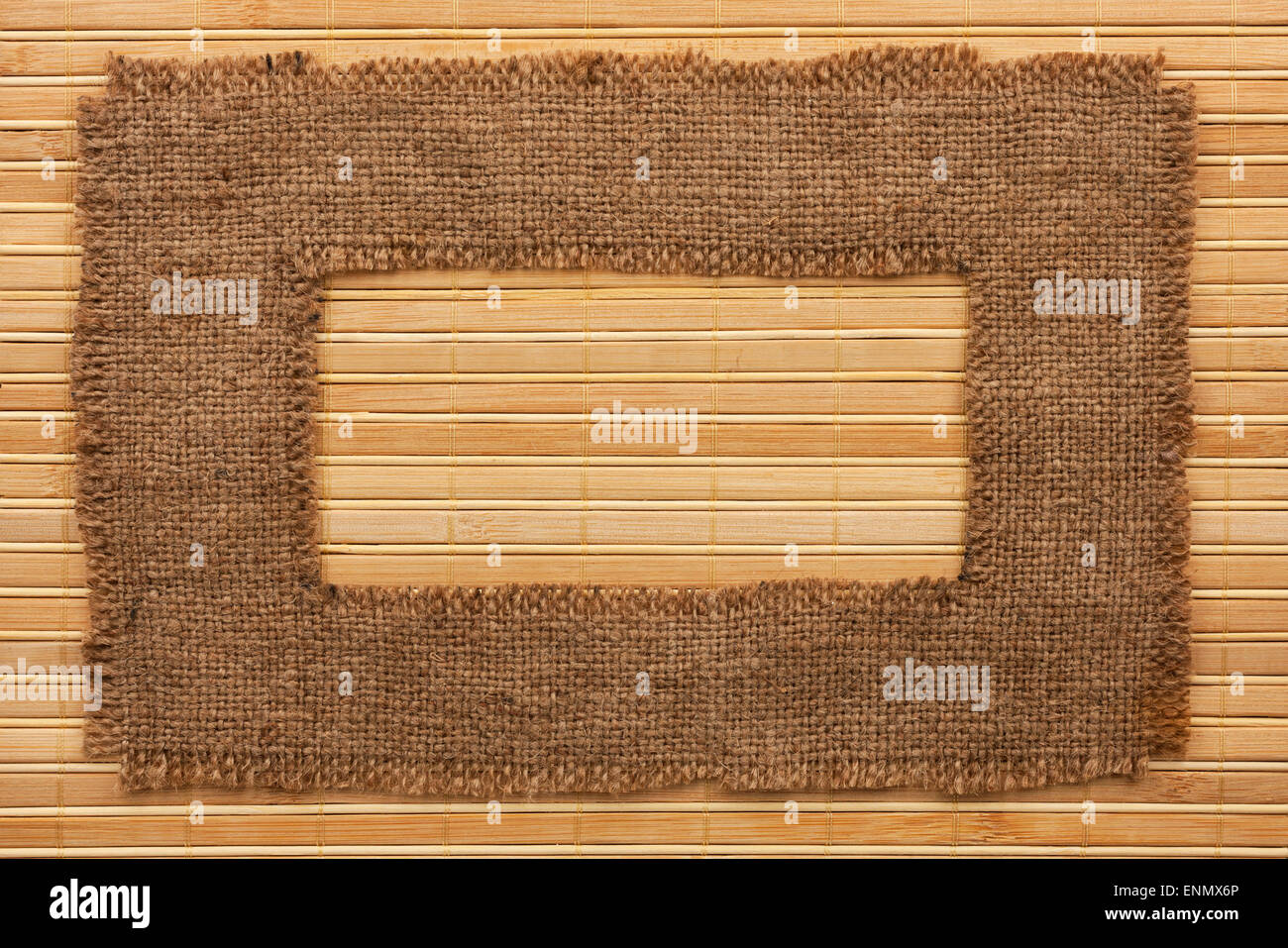 Frame made of burlap lying on a bamboo mat, with space for your text ...