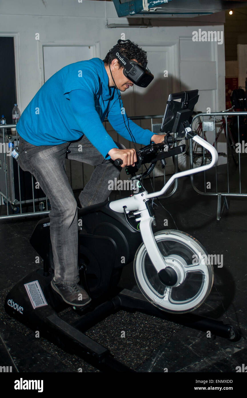 London, UK. 8 May 2015. A man rides a prototype 3D virtual reality ...