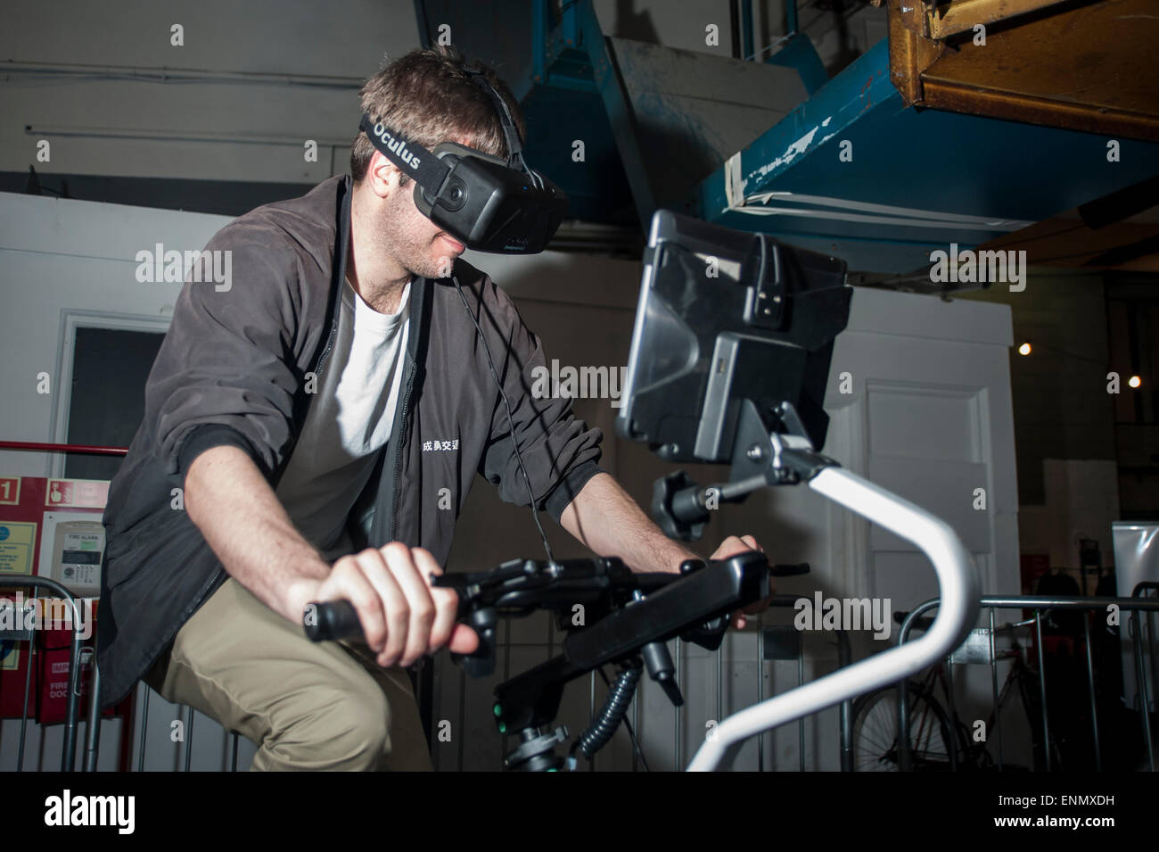 London, UK. 8 May 2015. A man rides a prototype 3D virtual reality ...