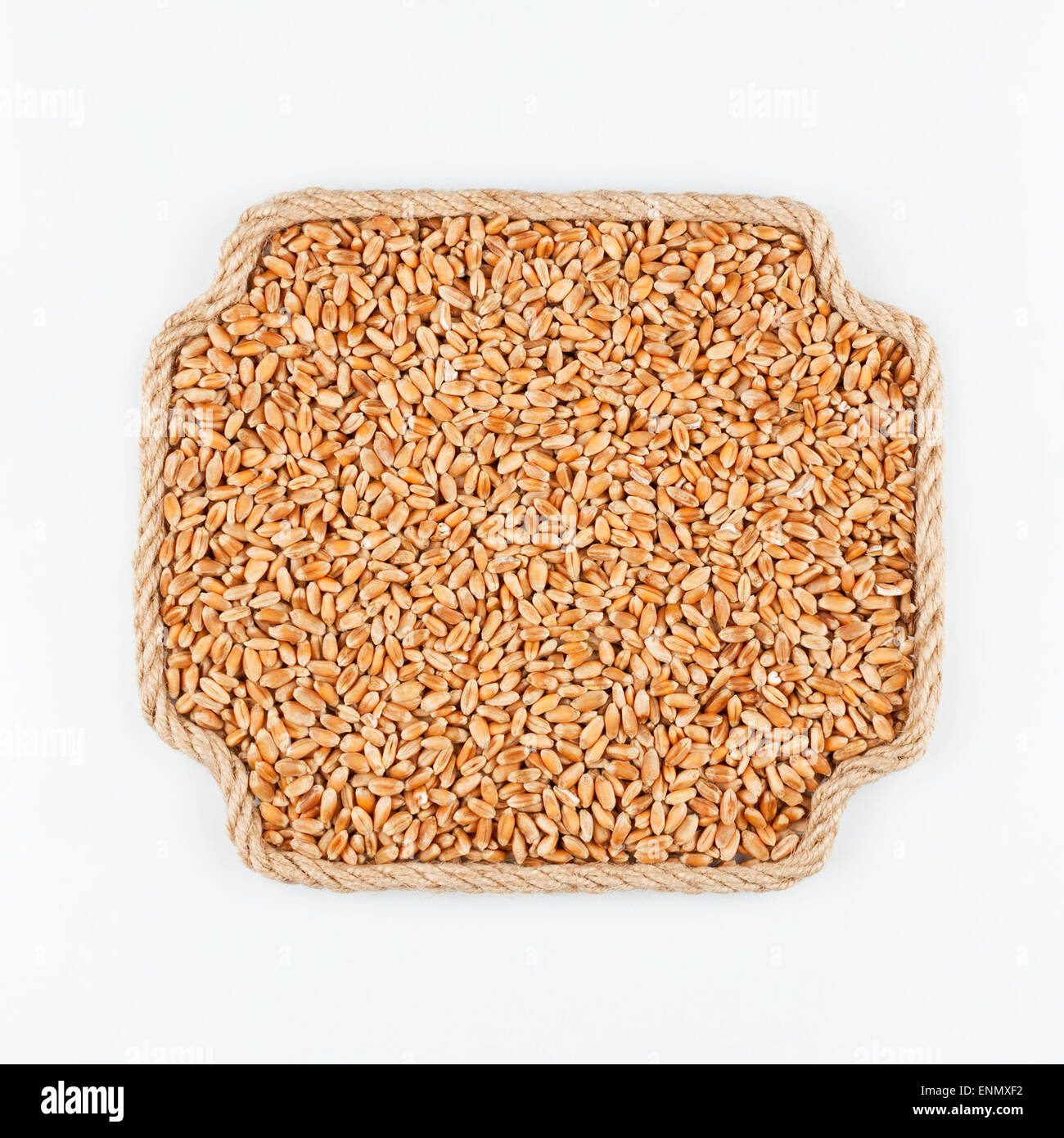 Frame made of rope with wheat lying on a white background, with place ...