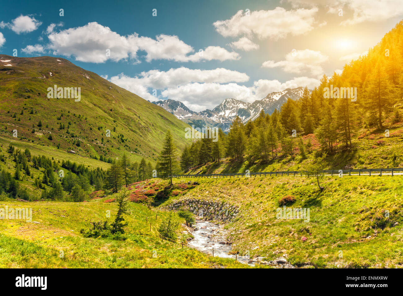 Colorful Alpine landscape scenery with sun setting down Stock Photo - Alamy