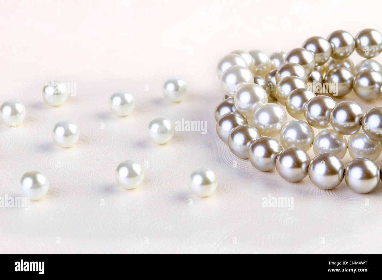Silver and White pearls necklace on white paper background Stock Photo ...