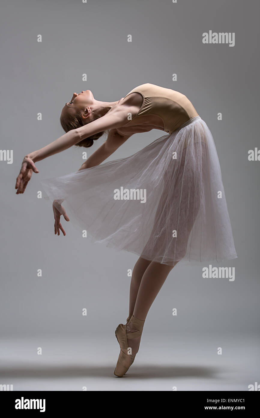 Graceful ballerina standing on toes bending the back Stock Photo - Alamy
