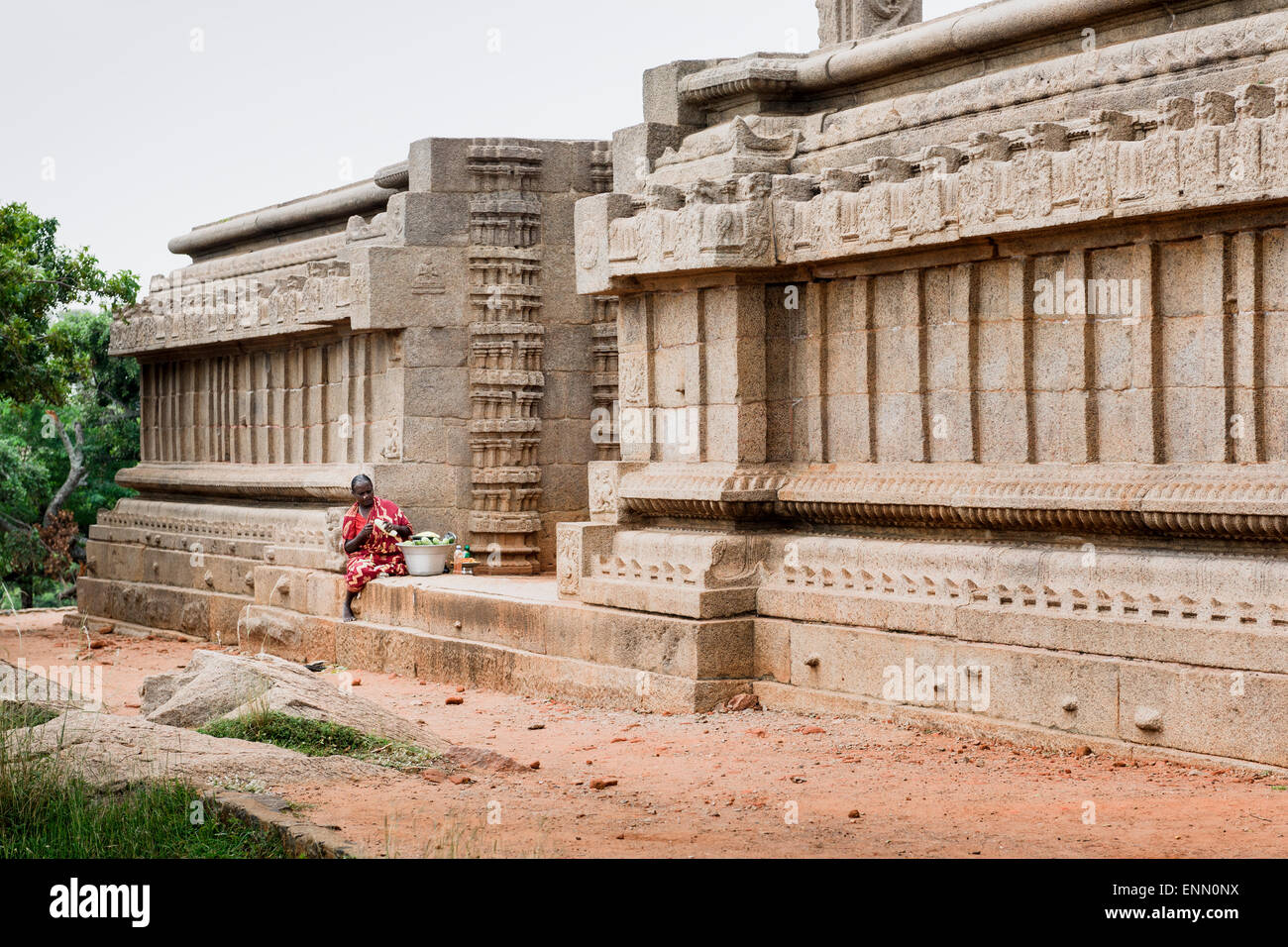 A lady selling refreshing pineapple and unripened mango in the Temple ...