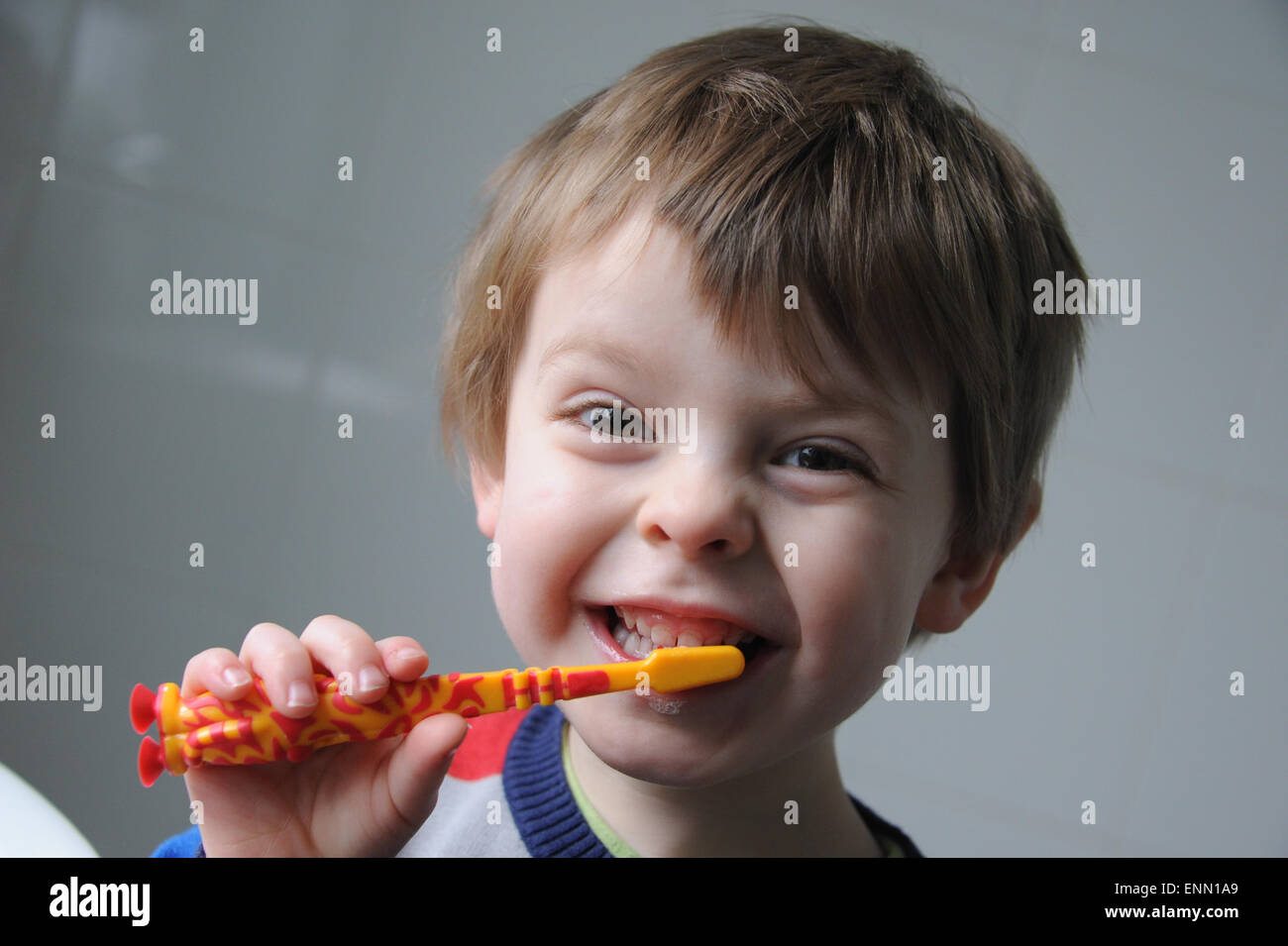 A three-year-old boy cleaning his teeth with a toothbrush Stock Photo ...