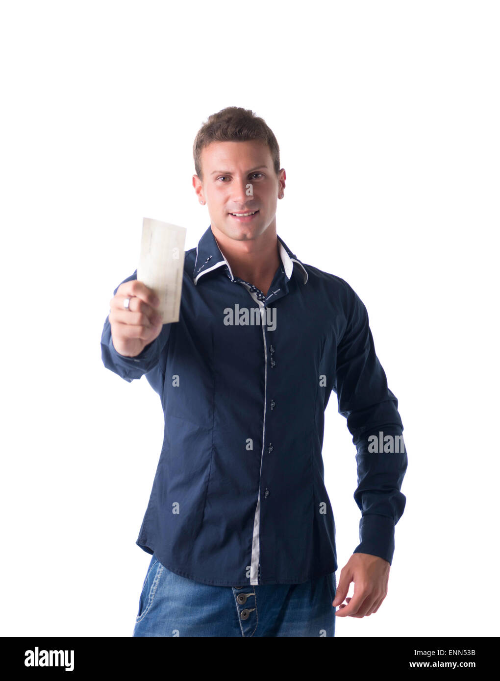 Young man showing check or cheque in his hands, looking at camera ...