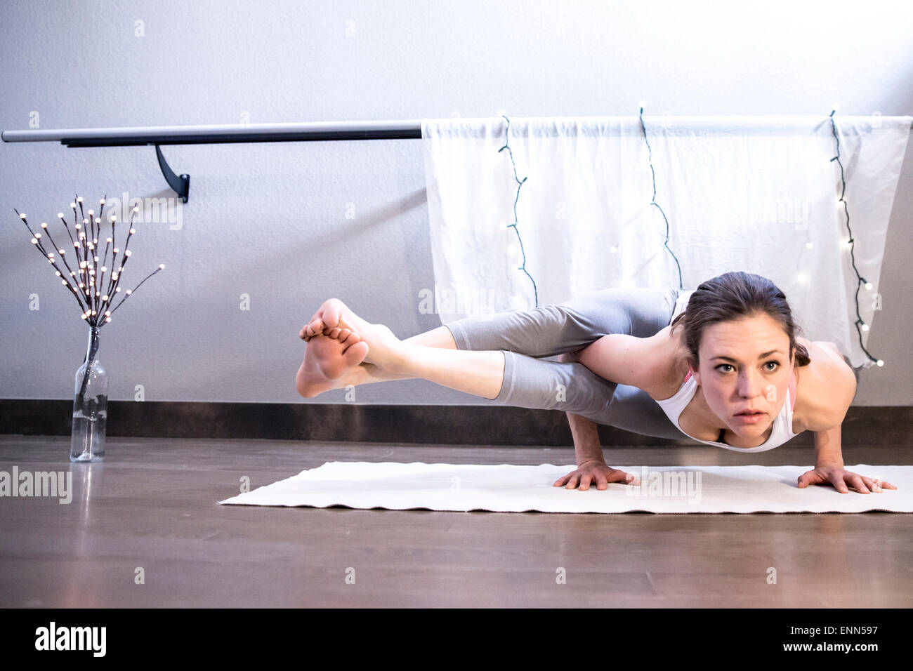 Strong Female holds yoga arm balance Stock Photo - Alamy
