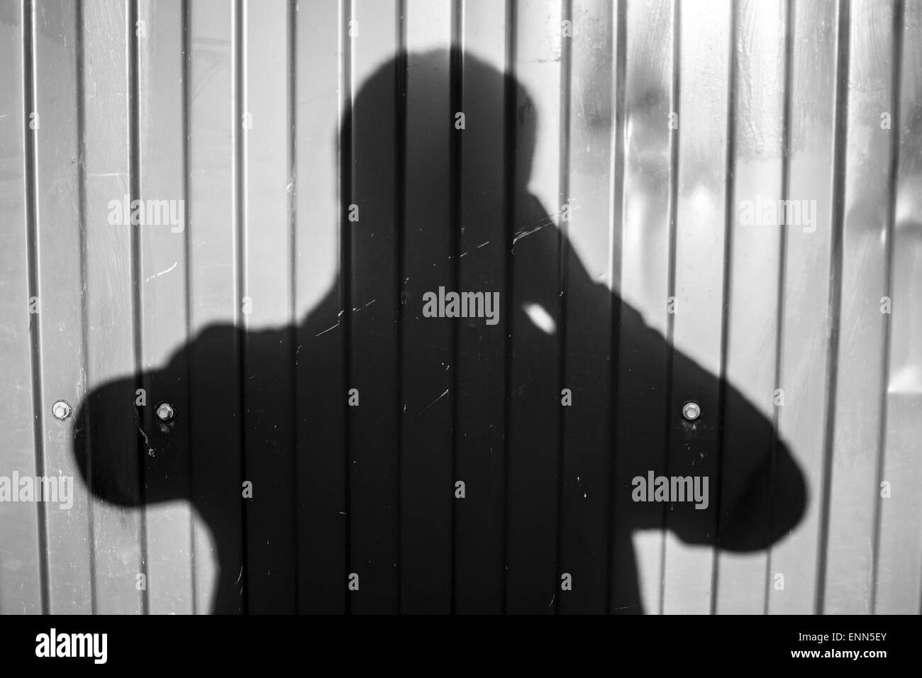 Photographer taking a photo casting shadows on a wall in black and ...