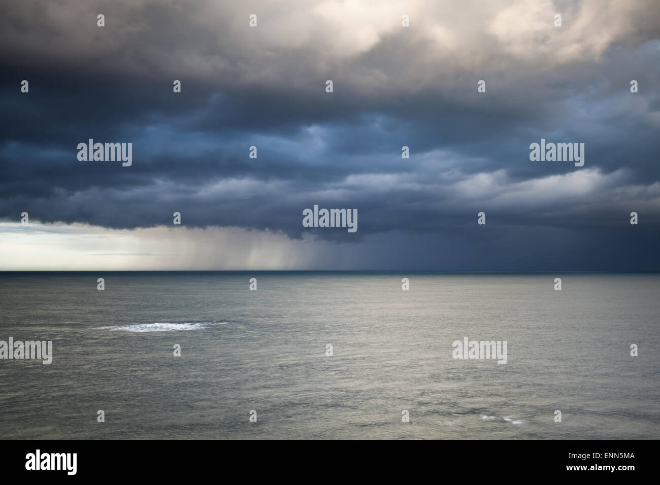 Intense rain storm out over the North Sea with blue and silver moody ...