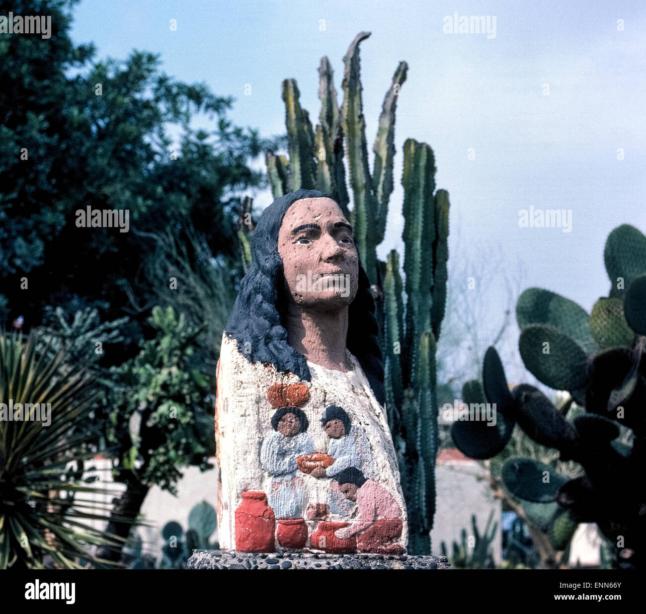 A rustic weathered sculpture of early American Indians is seen in the ...