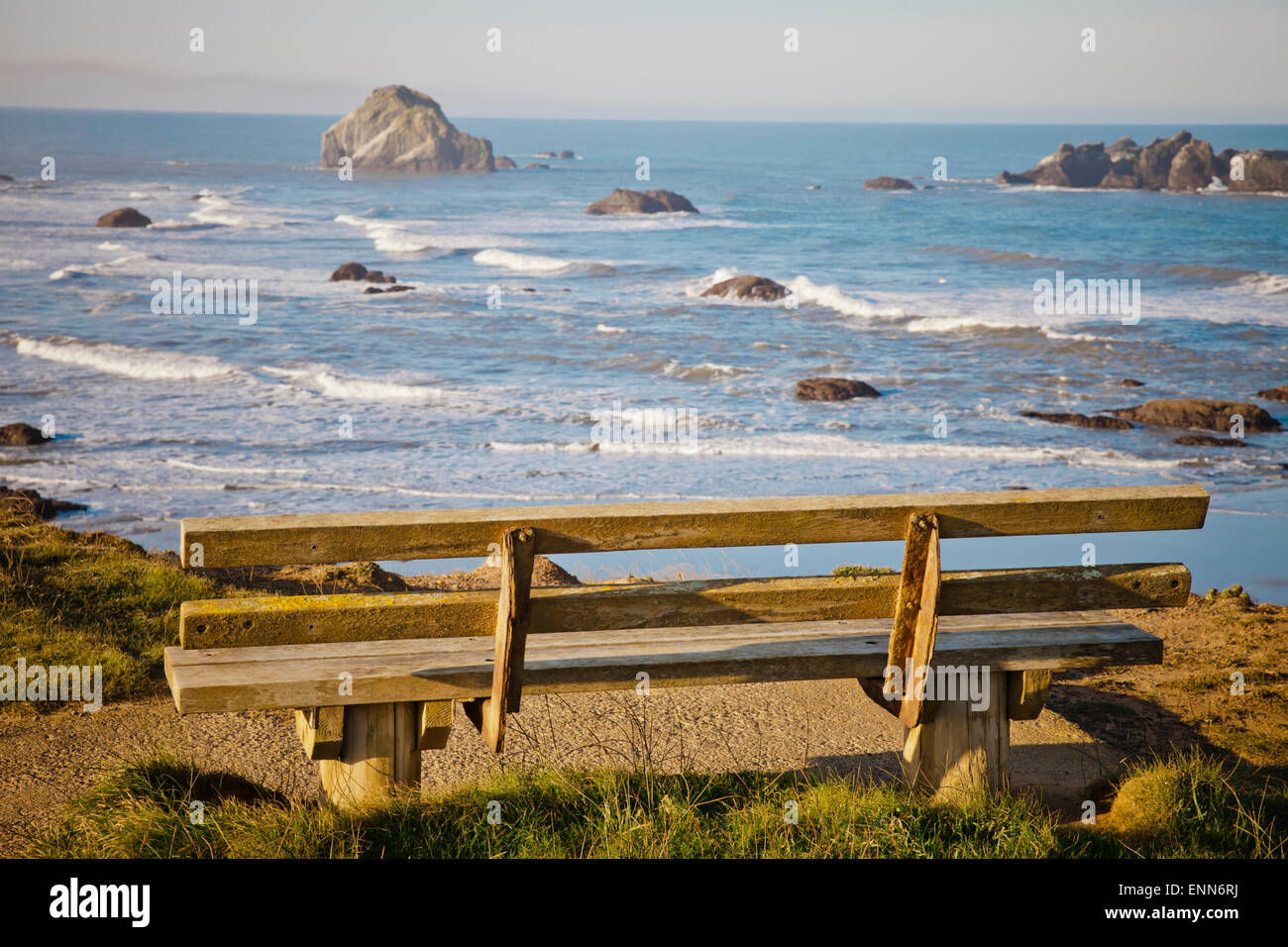An old weathered wooden bench looks out at Bandon Bay, Oregon Stock ...