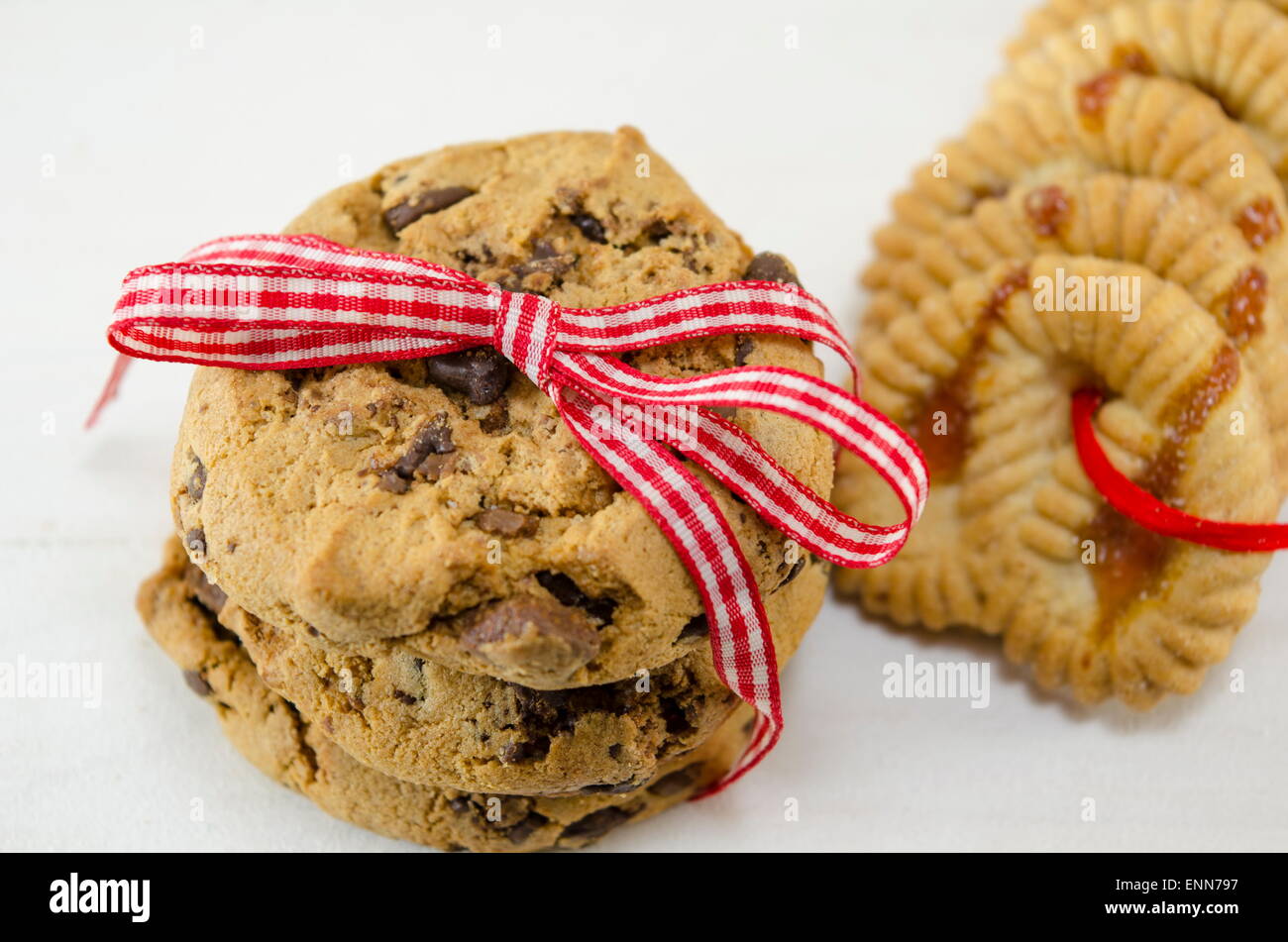 Chocolate chip cookies tied together with a red ribbon on white Stock ...