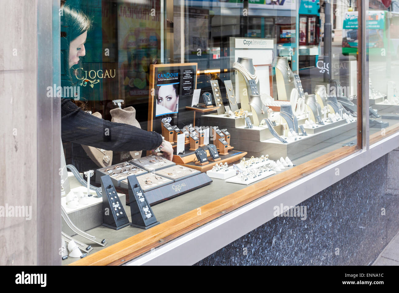 Woman arranging items in a jewellery shop window display. Nottingham ...