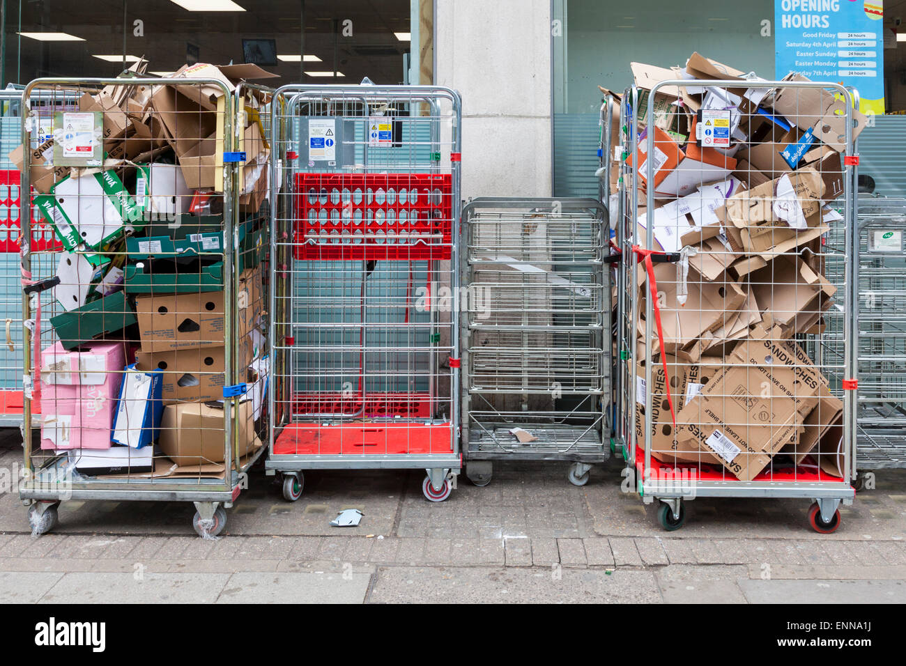 Roll cages or containers with shop waste on the pavement awaiting ...