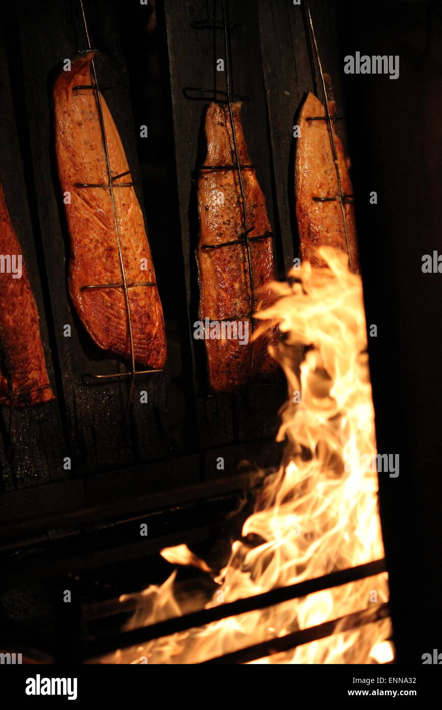 Salmon being smoked by an open wood fire Stock Photo - Alamy