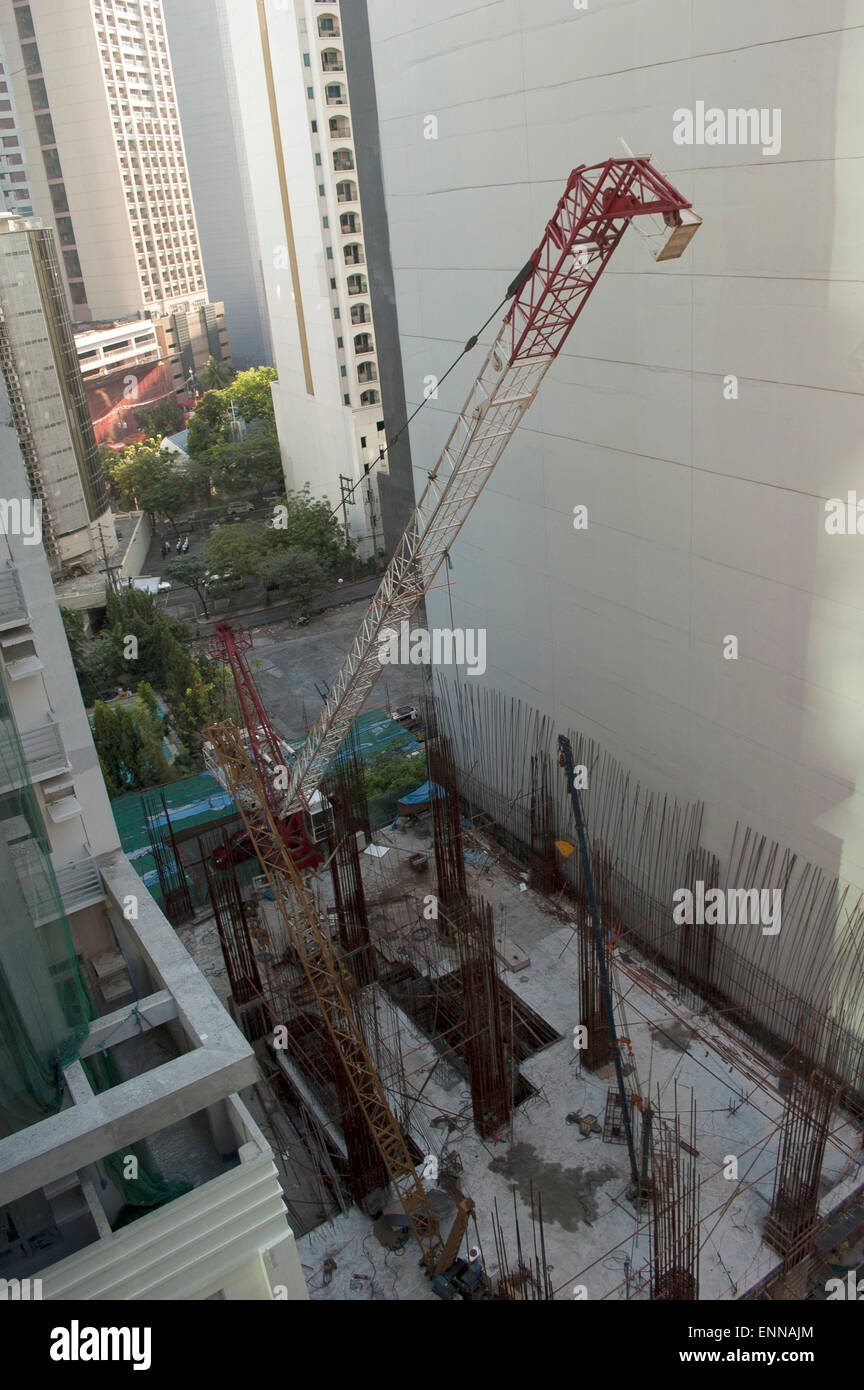 Crane working in between the high rise buildings of Salcedo Village ...