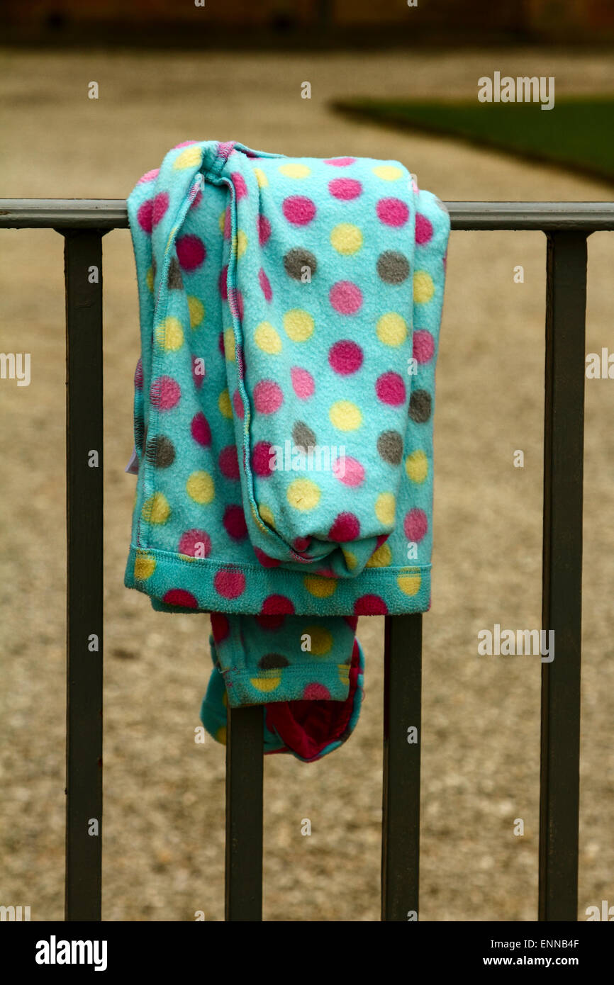 Lost children's jacket hanging over railings Stock Photo - Alamy